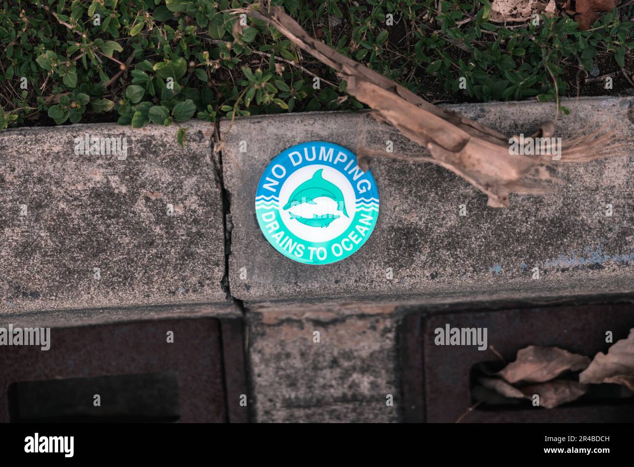 A “No Dumping” sign is applied next to a storm drain during Operation ...