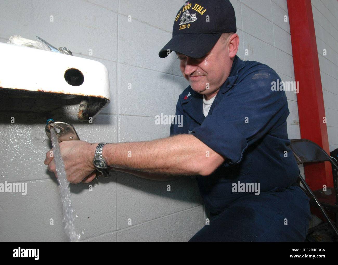 US Navy Aviation Structural Mechanic 1st Class prepares a connection ...