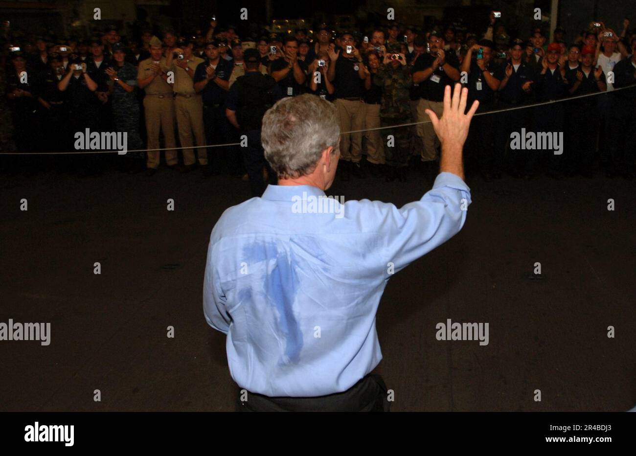 US Navy U.S. President George W. Bush waves to a waiting crowd of ...