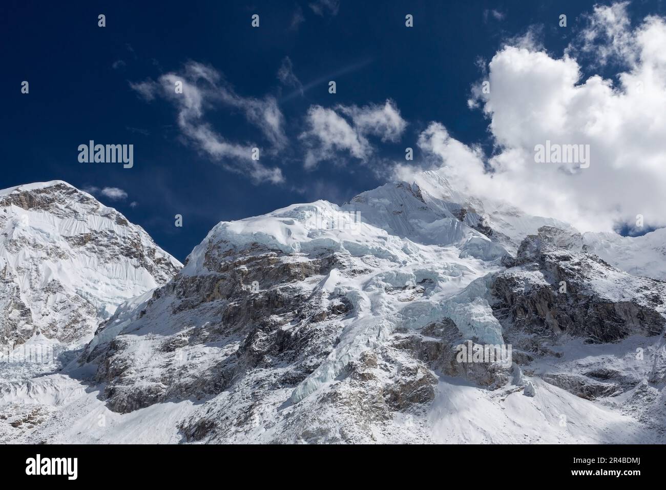 Beautiful snow and ice covered mountains view up to the peaks and blue ...