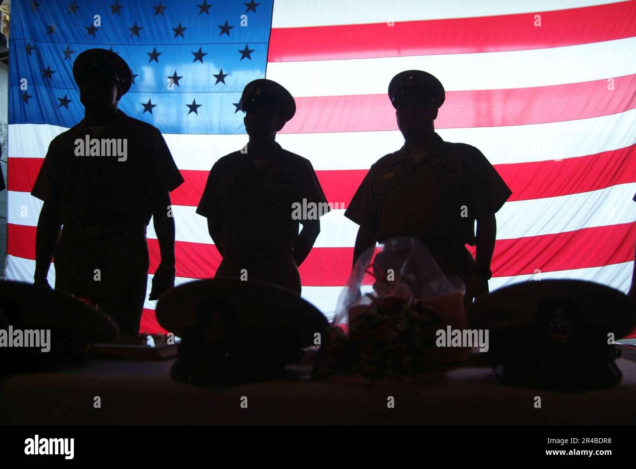 US Navy Chief petty officers (CPOs) stand behind the combination covers ...