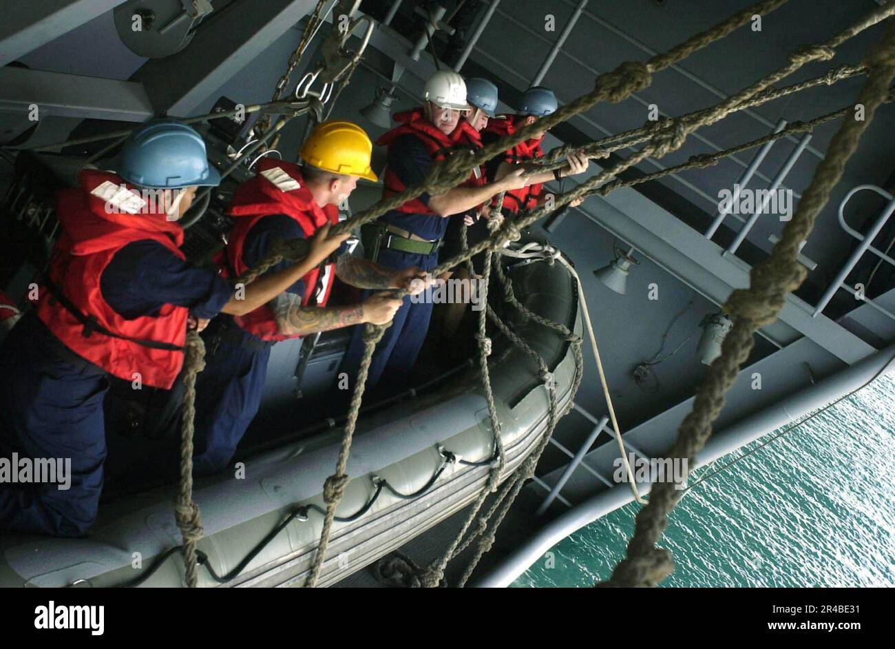 US Navy Deck department Sailors hoist a Rigid Hull Inflatable Boat ...