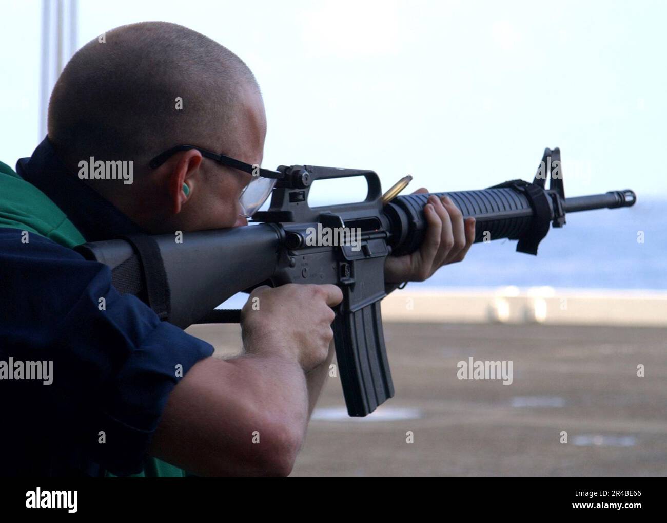 US Navy A Sailor fires an M-16 assault rifle, during a small arms ...