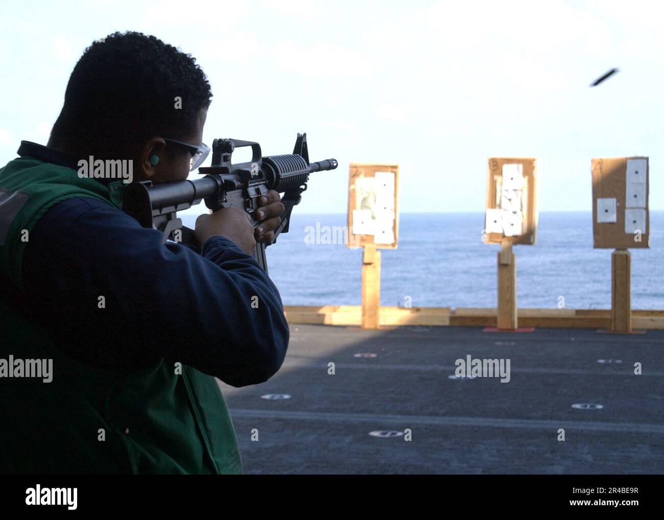 US Navy A Sailor fires an M-4 carbine, during a small arms ...