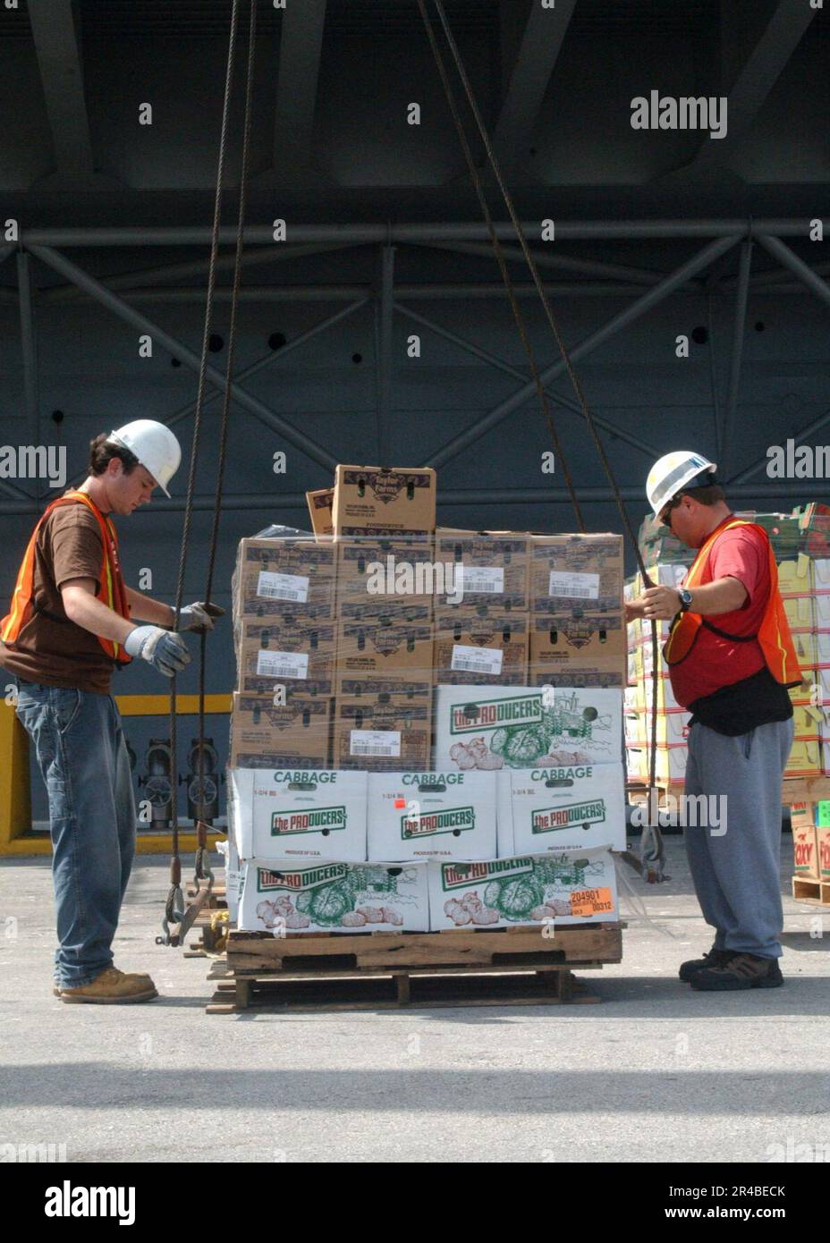 US Navy Civilian contractors load pallets of food supplies onto the ...