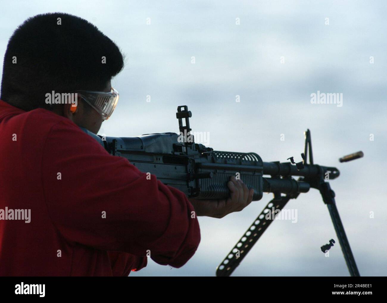 US Navy A Sailor assigned to Weapons Department fires a M-60 machine ...