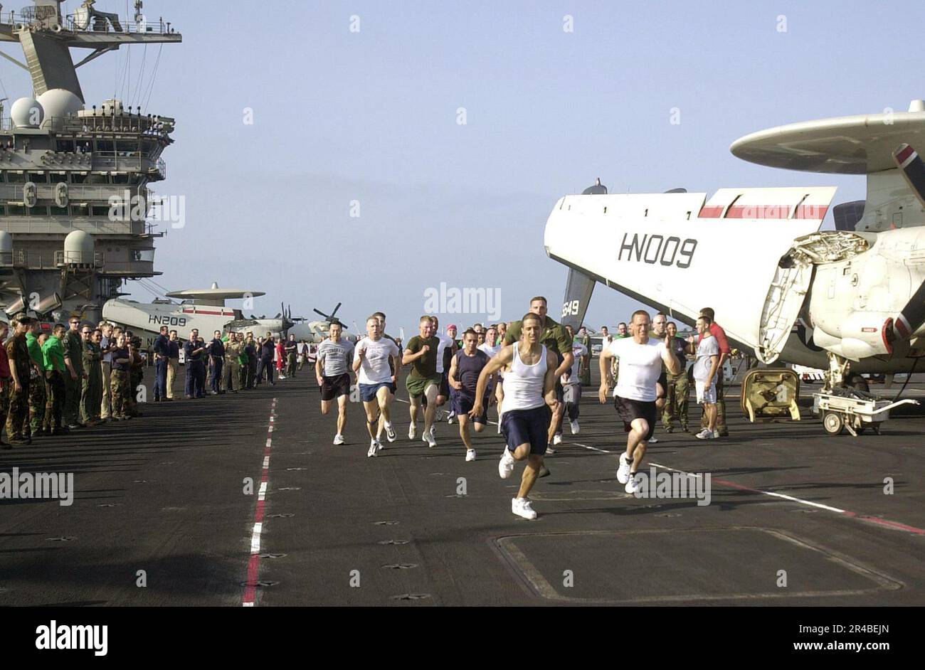 US Navy Crew members run a race on the flight deck aboard the nuclear ...