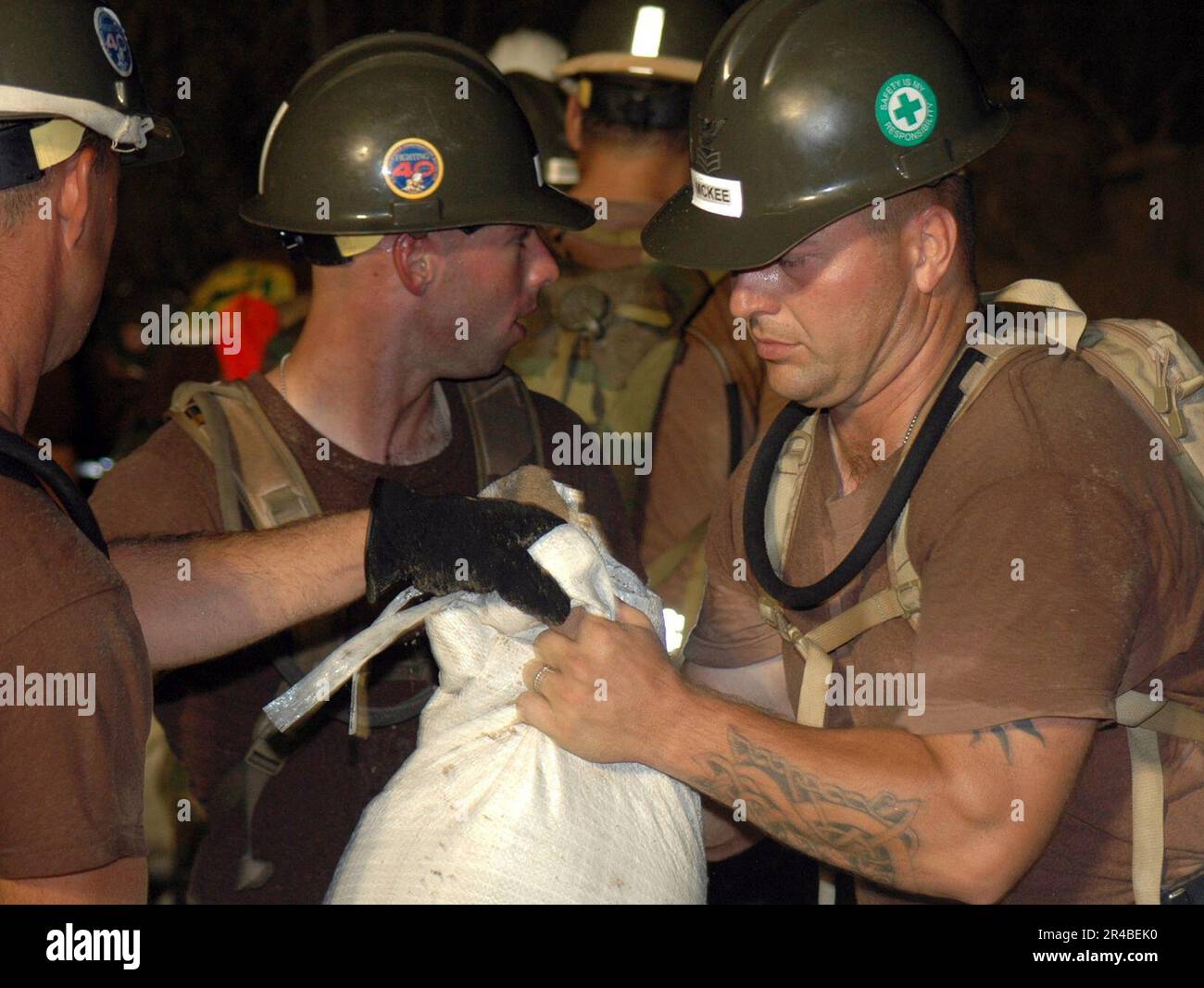 US Navy U.S. Navy Builder 1st Class right, assigned to Naval Mobile ...