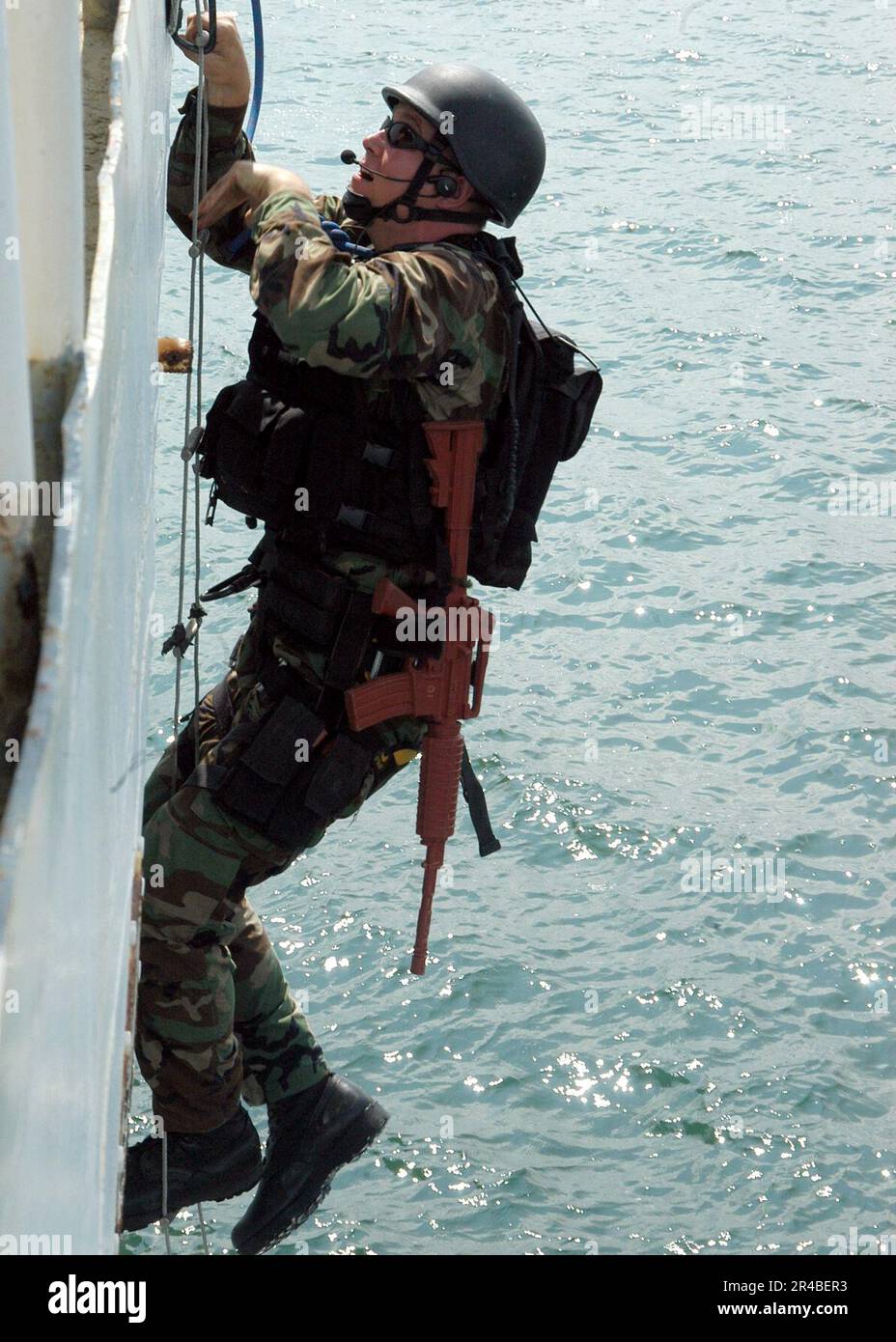 Us Navy A Sailor Assigned To The Guided Missile Cruiser Uss Cowpens Cg 63 Climbs A Ladder To