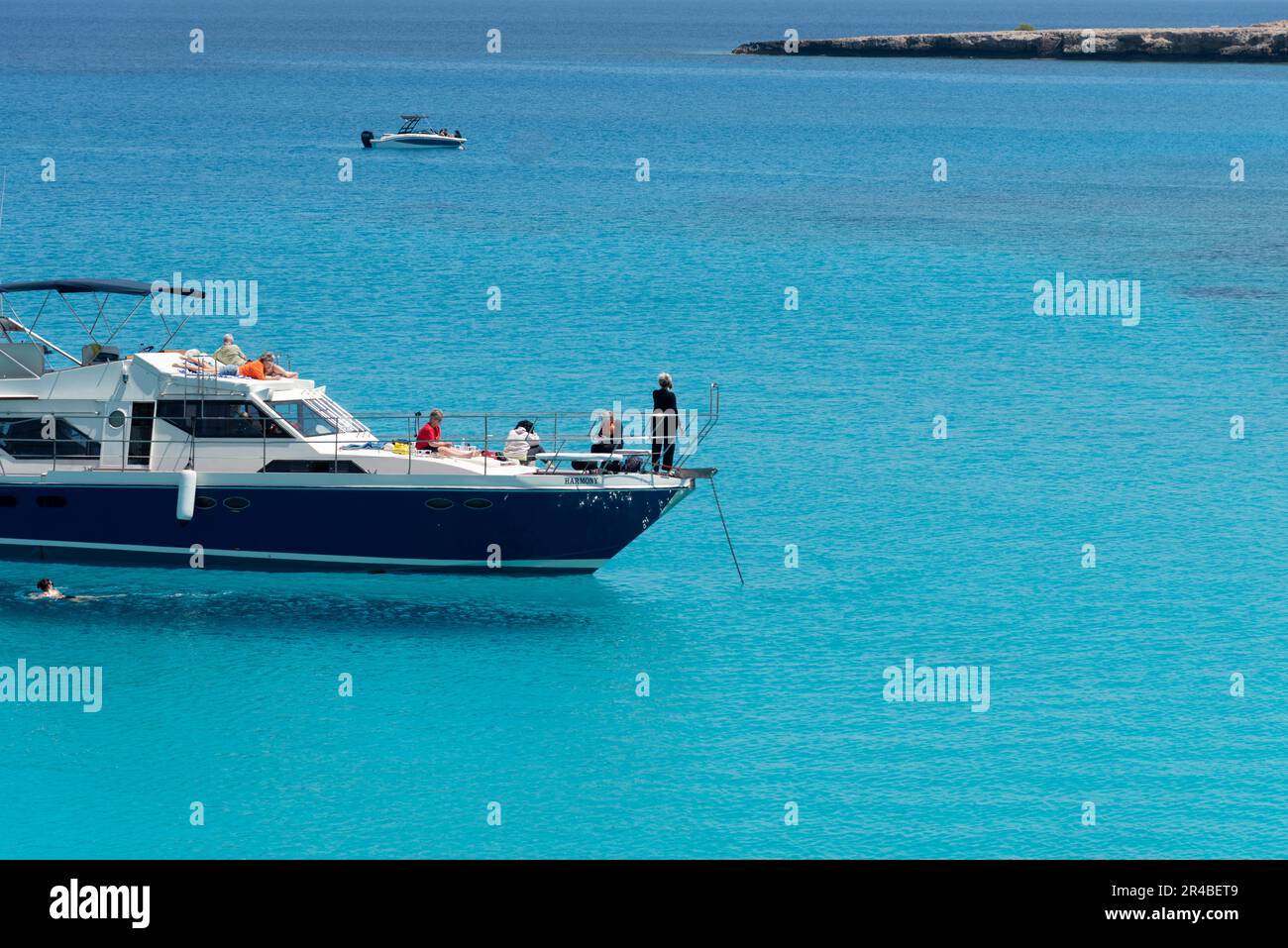 Tourist yacht sailing in the sea with tourists enjoying summer holidays ...