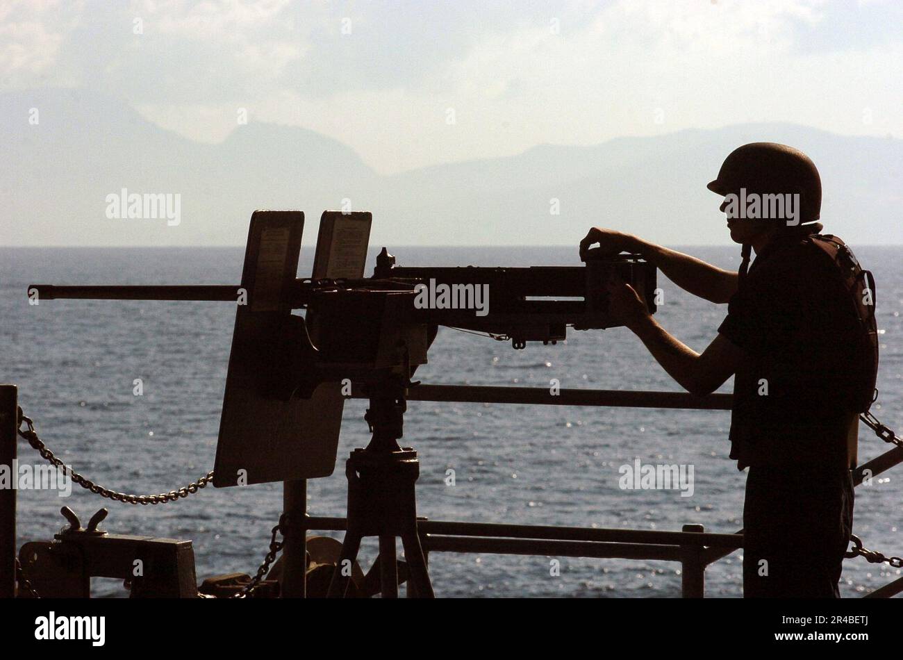US Navy Airman mans a .50 caliber gun mount during self-defense ...