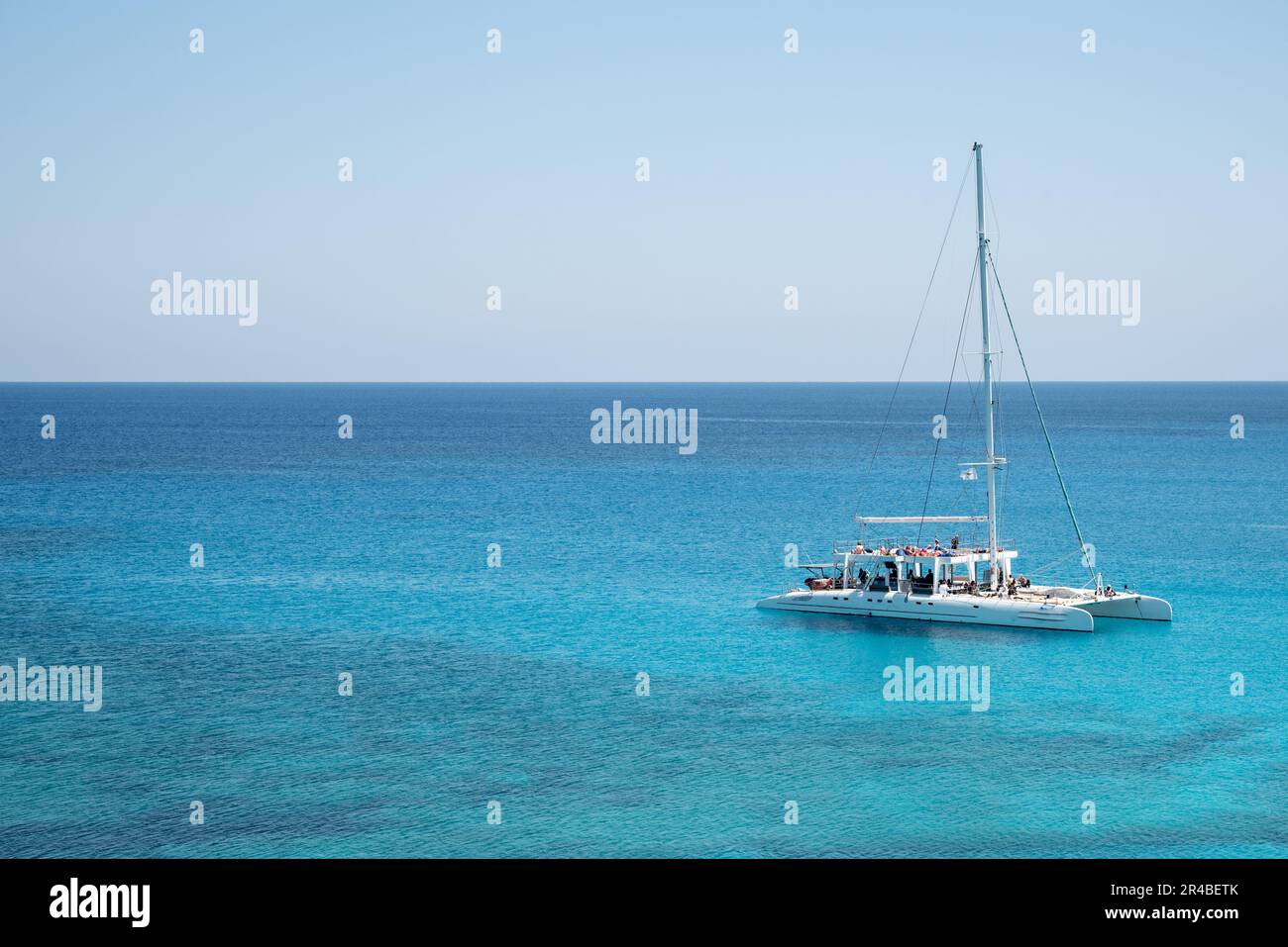 Tourist yacht sailing in the sea with tourists enjoying summer holidays ...