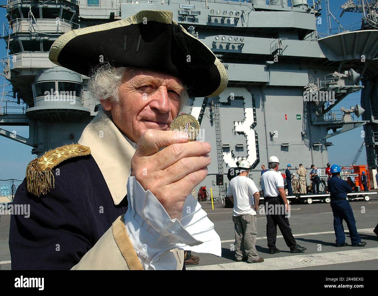 US Navy A General George Washington impersonator, displays a ship's ...
