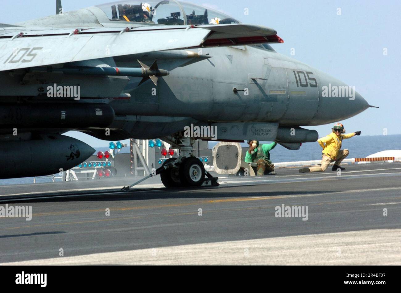 US Navy Lt. Cmdr. gives the launch signal to an F-14D Tomcat, assigned ...