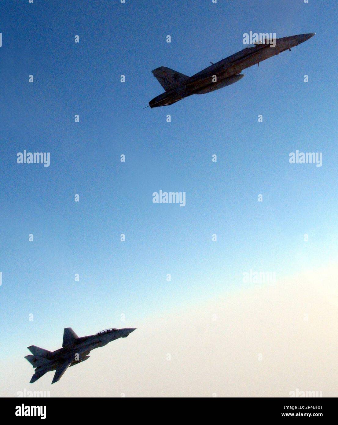 US Navy An F-A-18C Hornet and an F-14D Tomcat fly in a loose formation ...