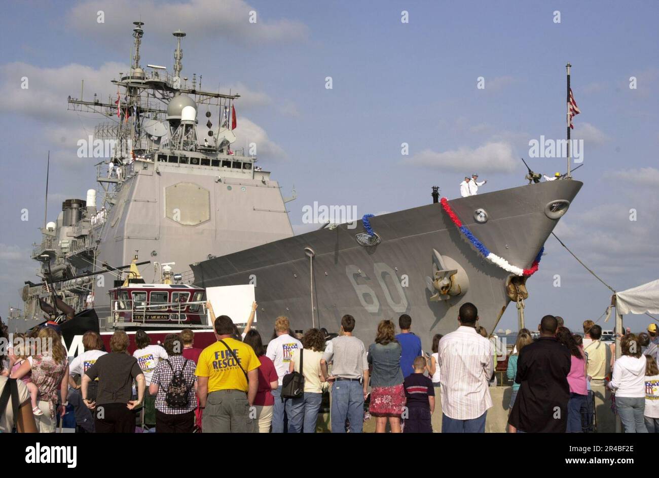 US Navy Friends and family wait on the pier as the guided-missile ...