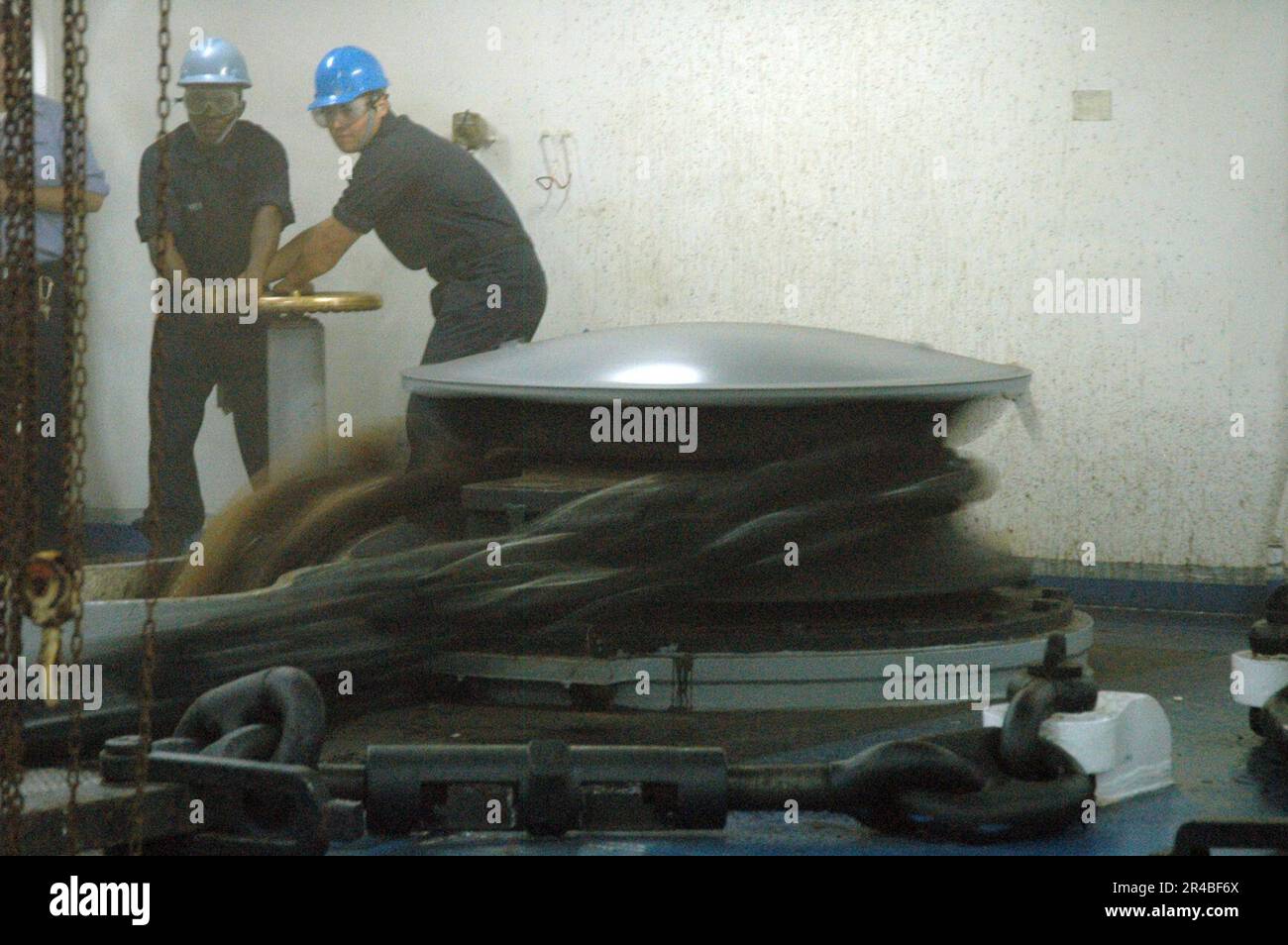 US Navy Deck Department personnel work together to anchor the ...