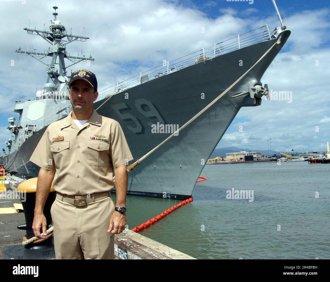 US Navy USS Russell (DDG 59) Commanding Officer Cmdr. stands in front ...