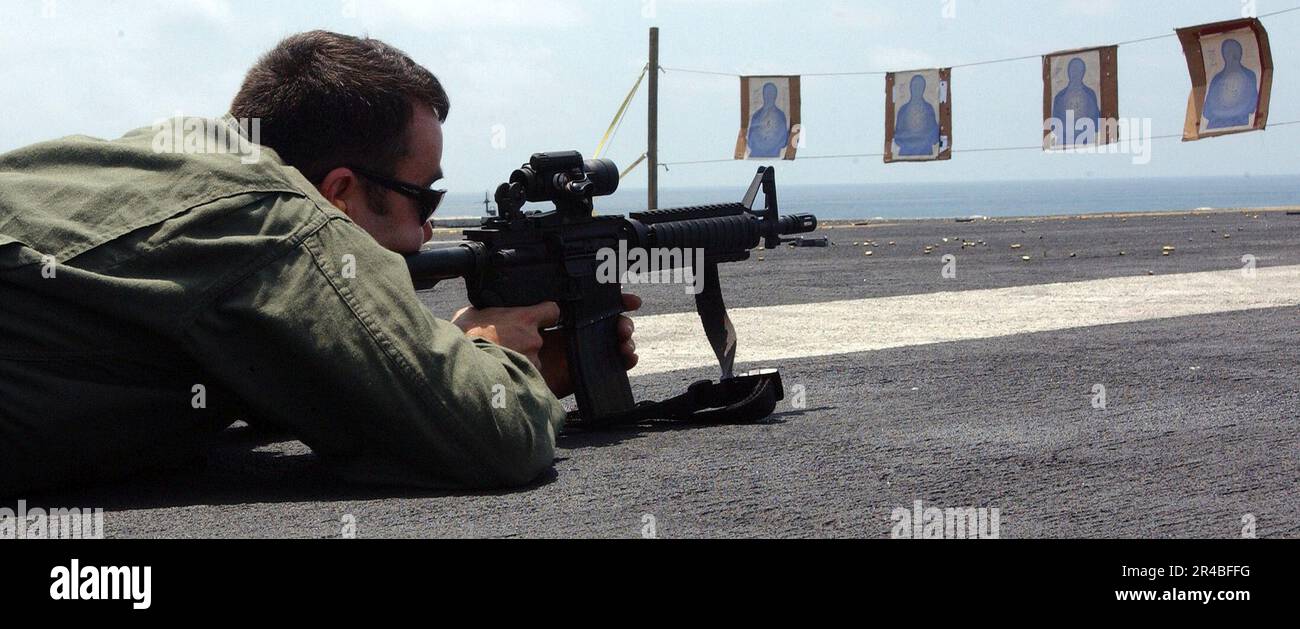 US Navy Aircrew Survival Equipmentman 1st Class shoots an M4-A1 assault ...