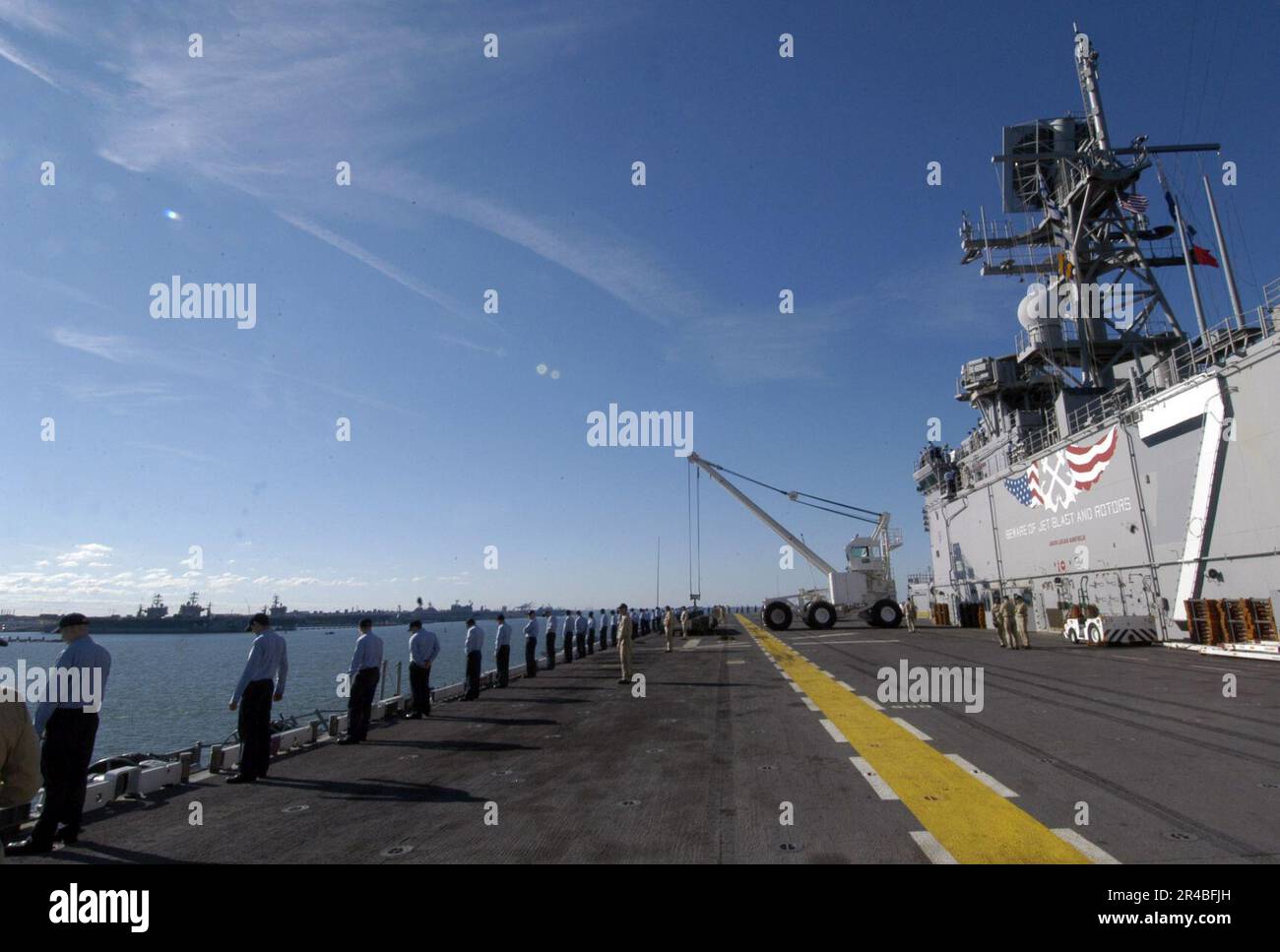 US Navy Sailors man the rails as the amphibious assault ship USS Iwo ...