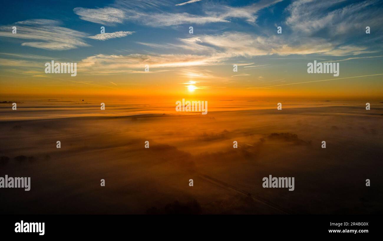 An aerial view of breathtaking landscape of the sun setting behind a ...
