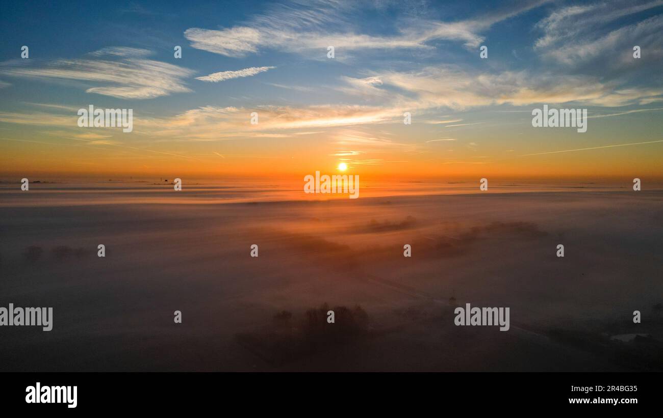 An aerial view of breathtaking landscape of the sun setting behind a ...