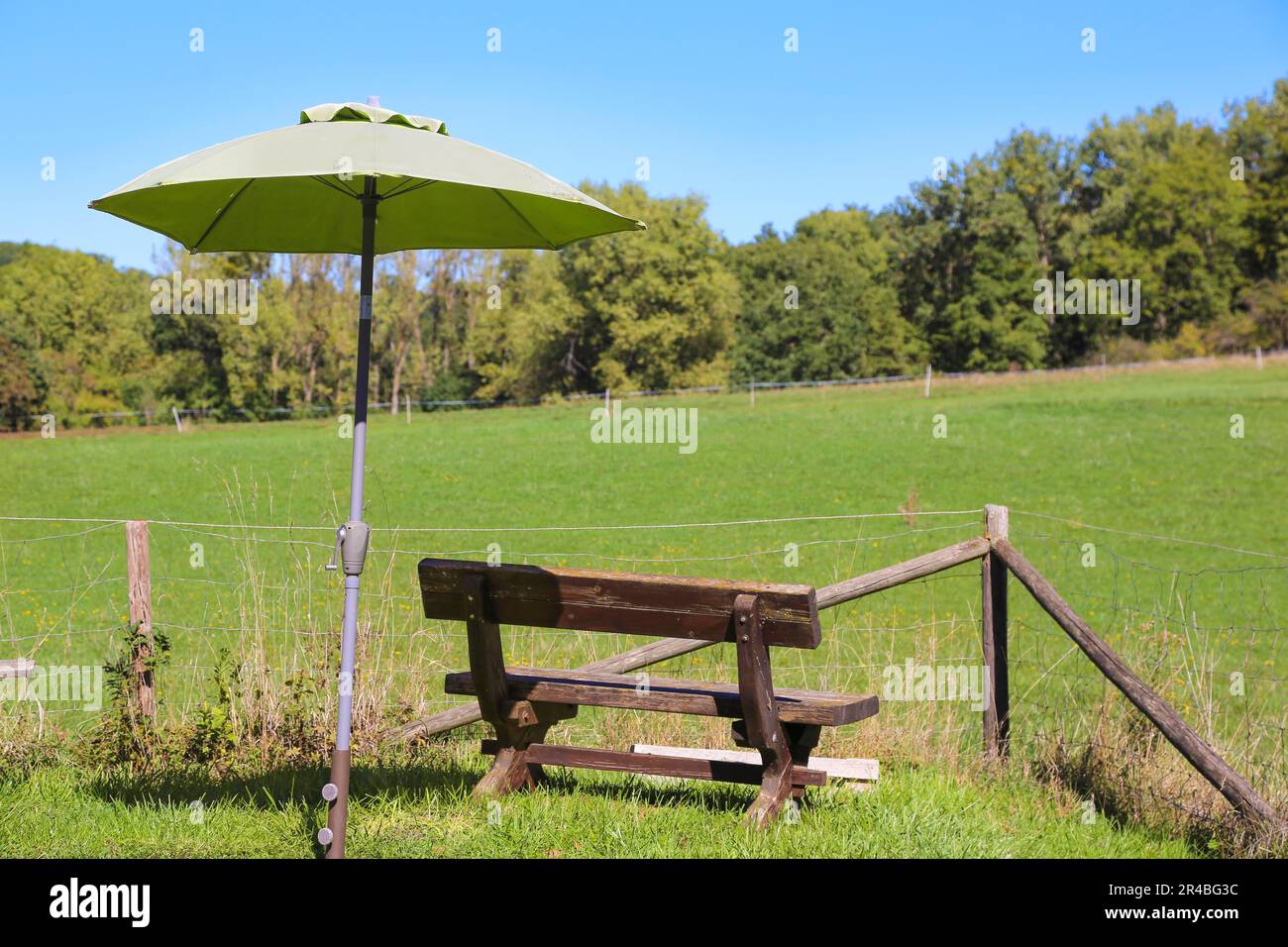Hofgut Rosenau, wooden bench with parasol, meadow, fence, garden ...