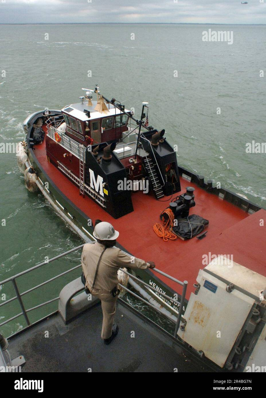 US Navy First Lieutenant, Lt. Cmdr. watches as the tugboat Wendy Moran ...