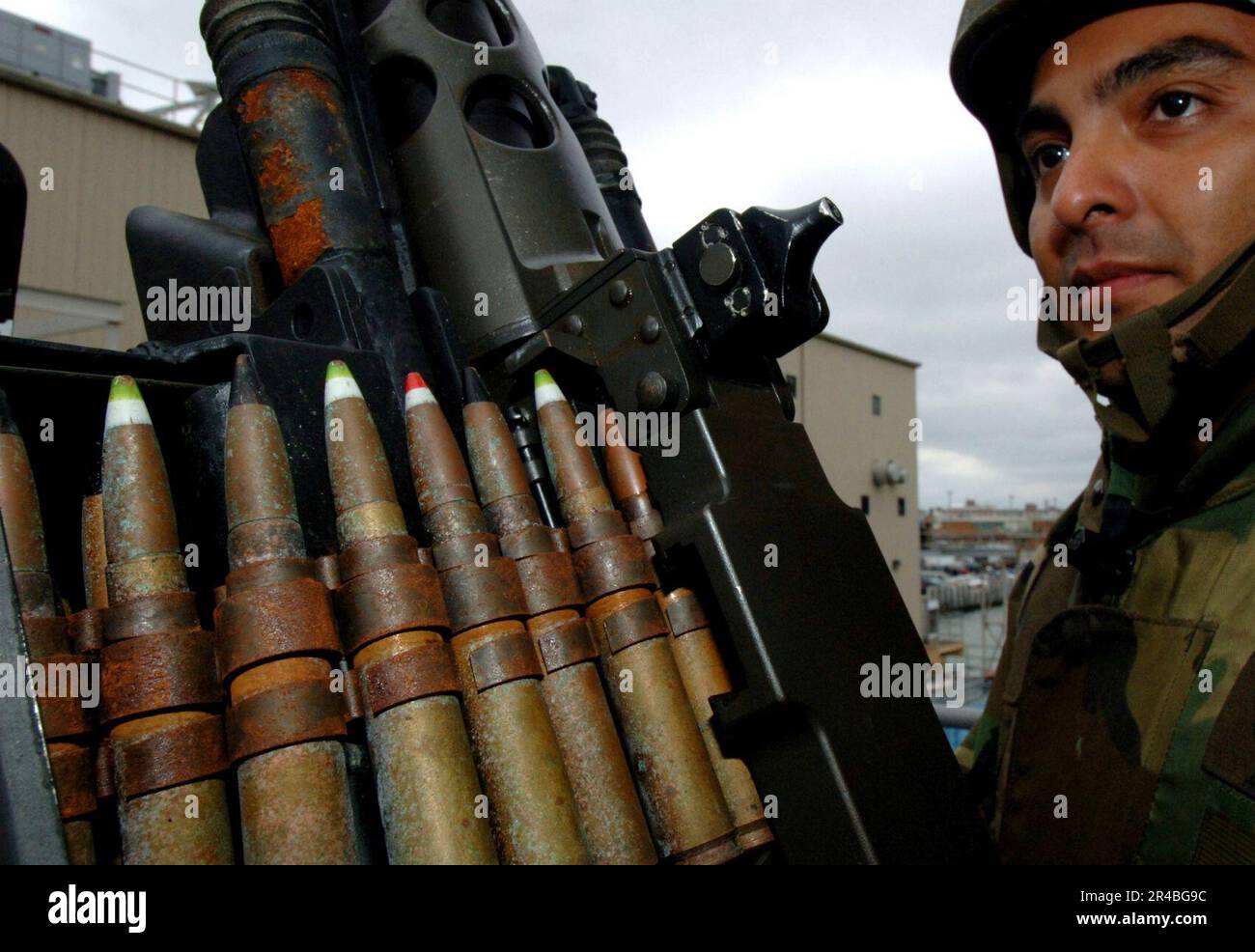 US Navy Draftsman 2nd Class stands a force security watch with a .50 ...