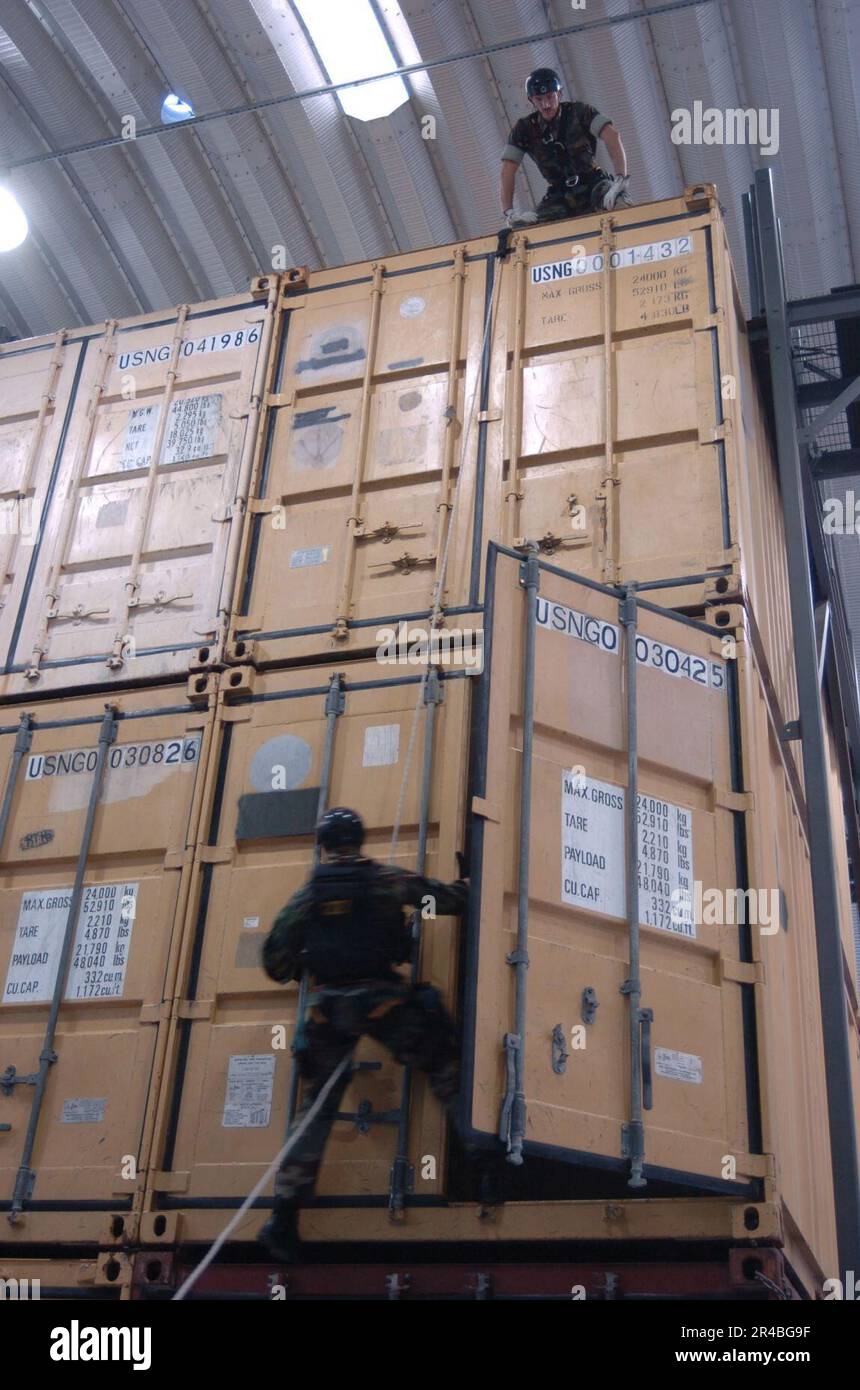 US Navy Instructors teach rappelling and container search maneuvers ...