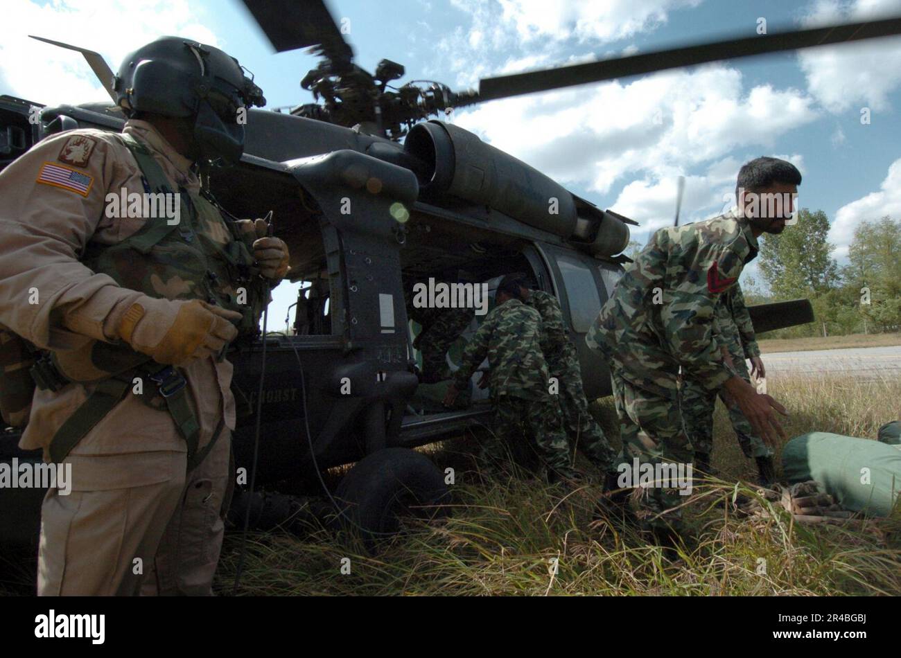 US Navy A U.S. Army aircrew member oversees the unloading of a UH-60 ...