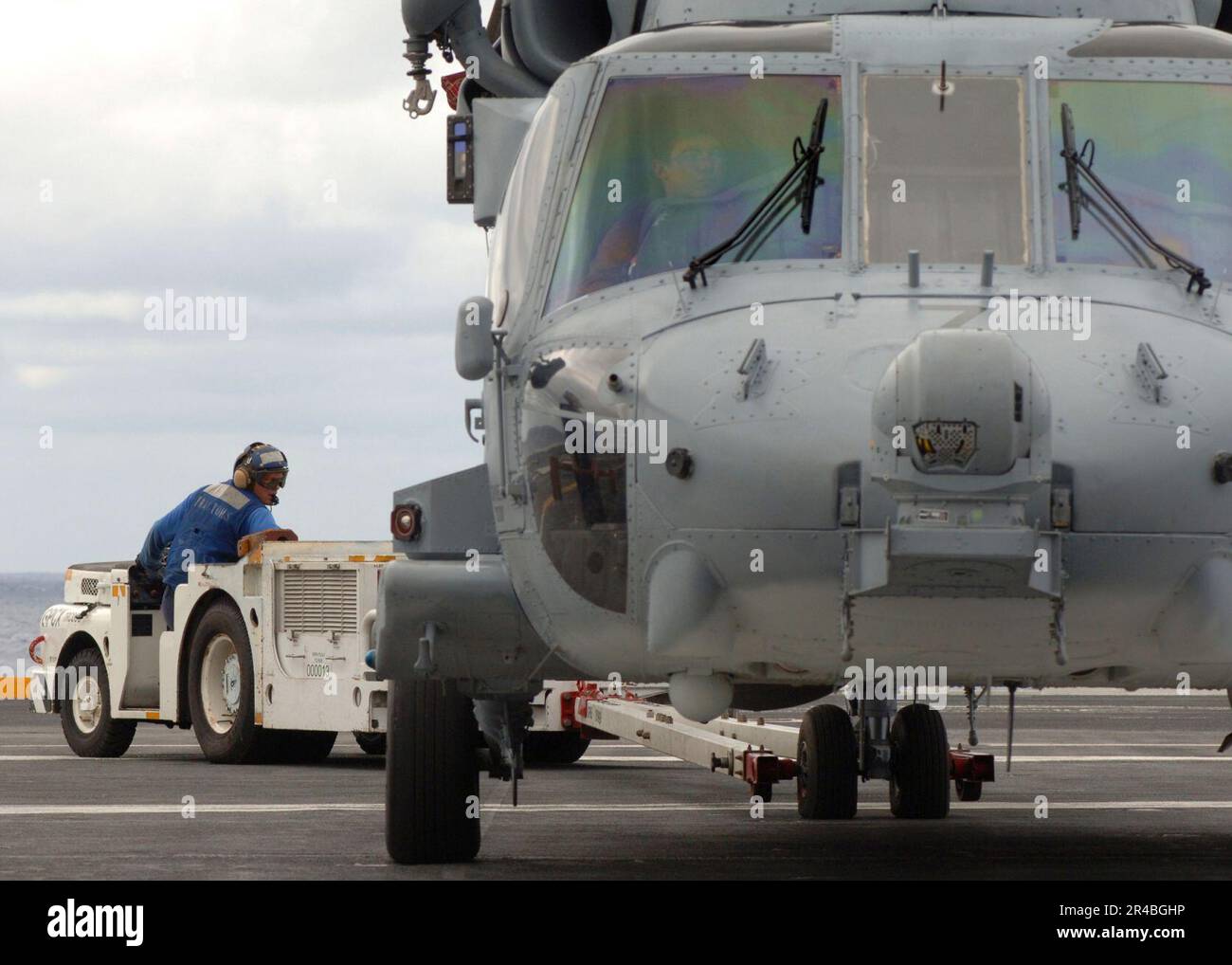 US Navy An Aviation Boatswain's Mate positions an HH-60H Seahawk ...