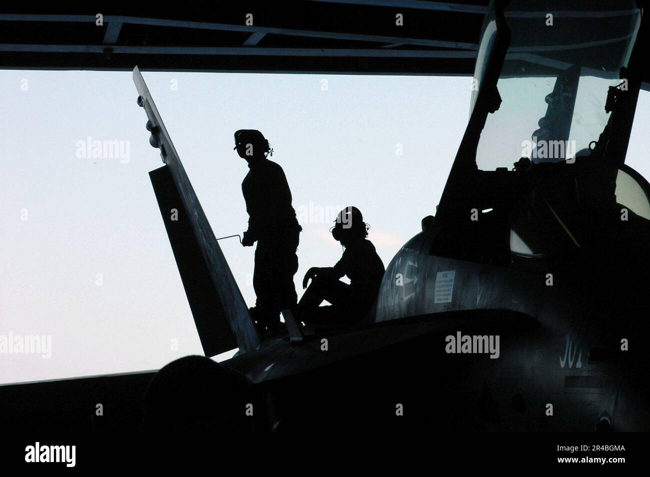 US Navy Marines performs maintenance on one of their squadron's F-A-18 ...