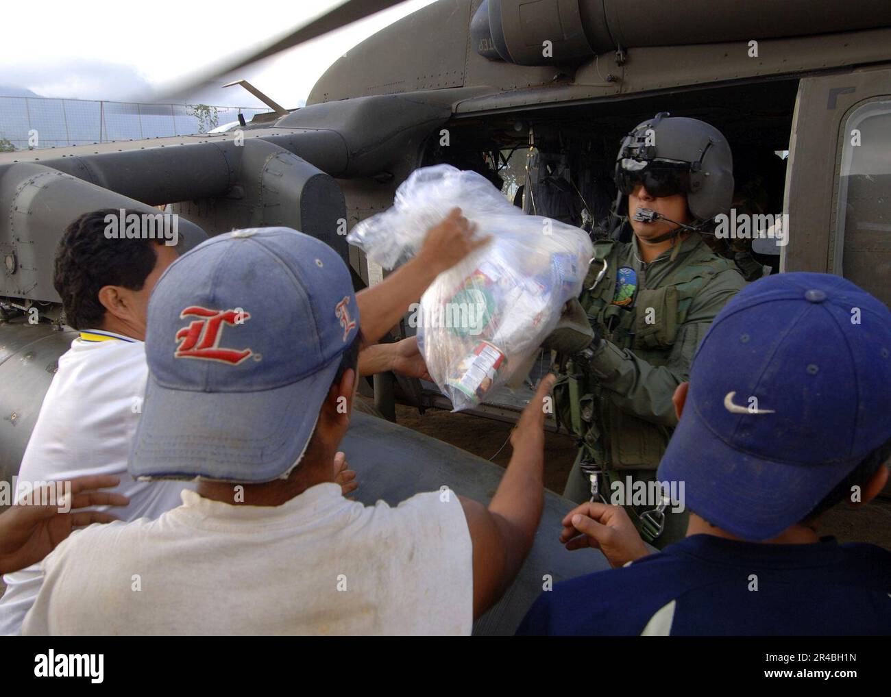 US Navy U.S. Army Spc. hands out food, water, and medicine from a UH-60 ... US Navy U.S. Army Spc. hands out food, water, and medicine from a UH-60 ...