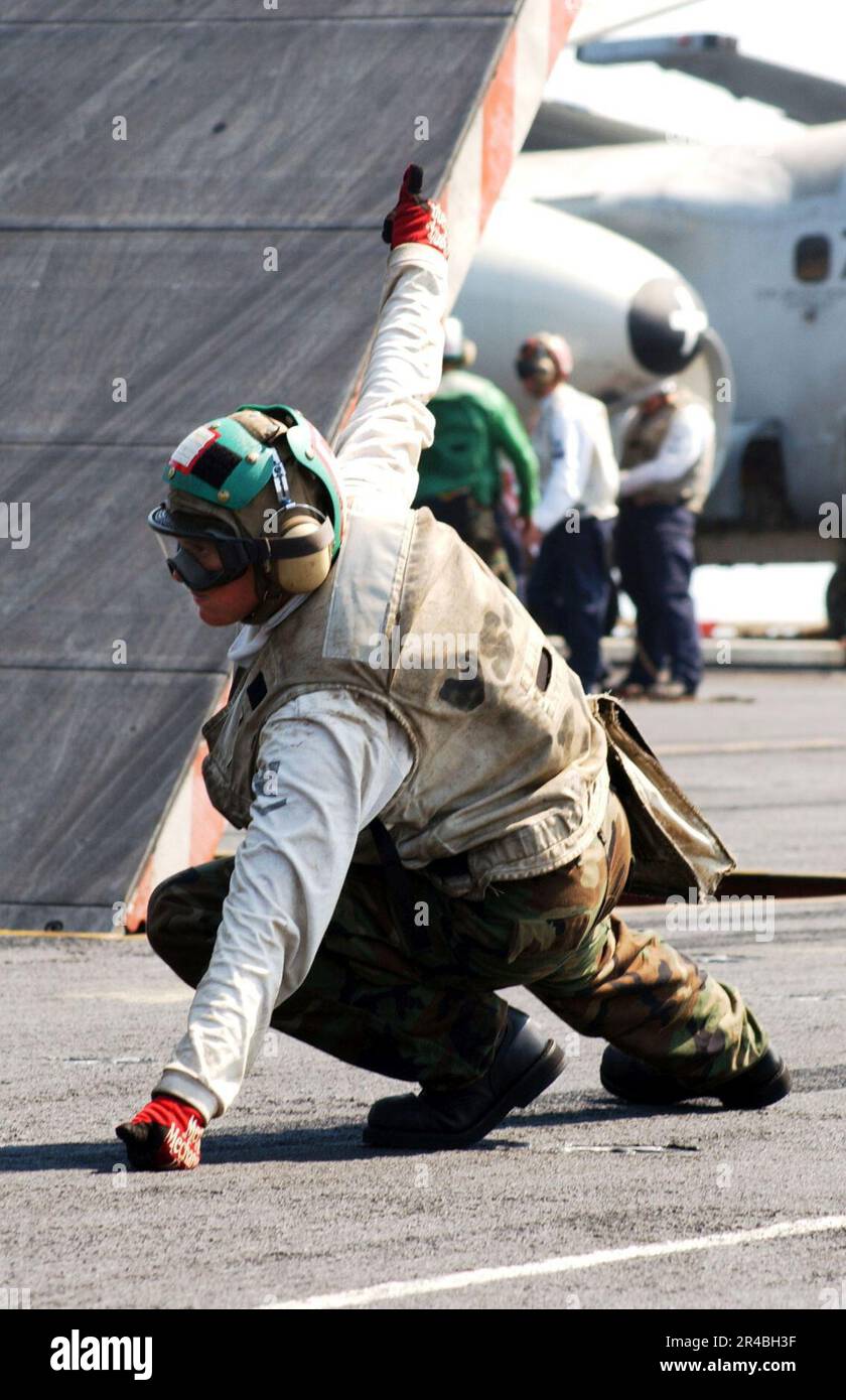 US Navy Aircrew Survival Equipmentman 3rd Class signals that the ...