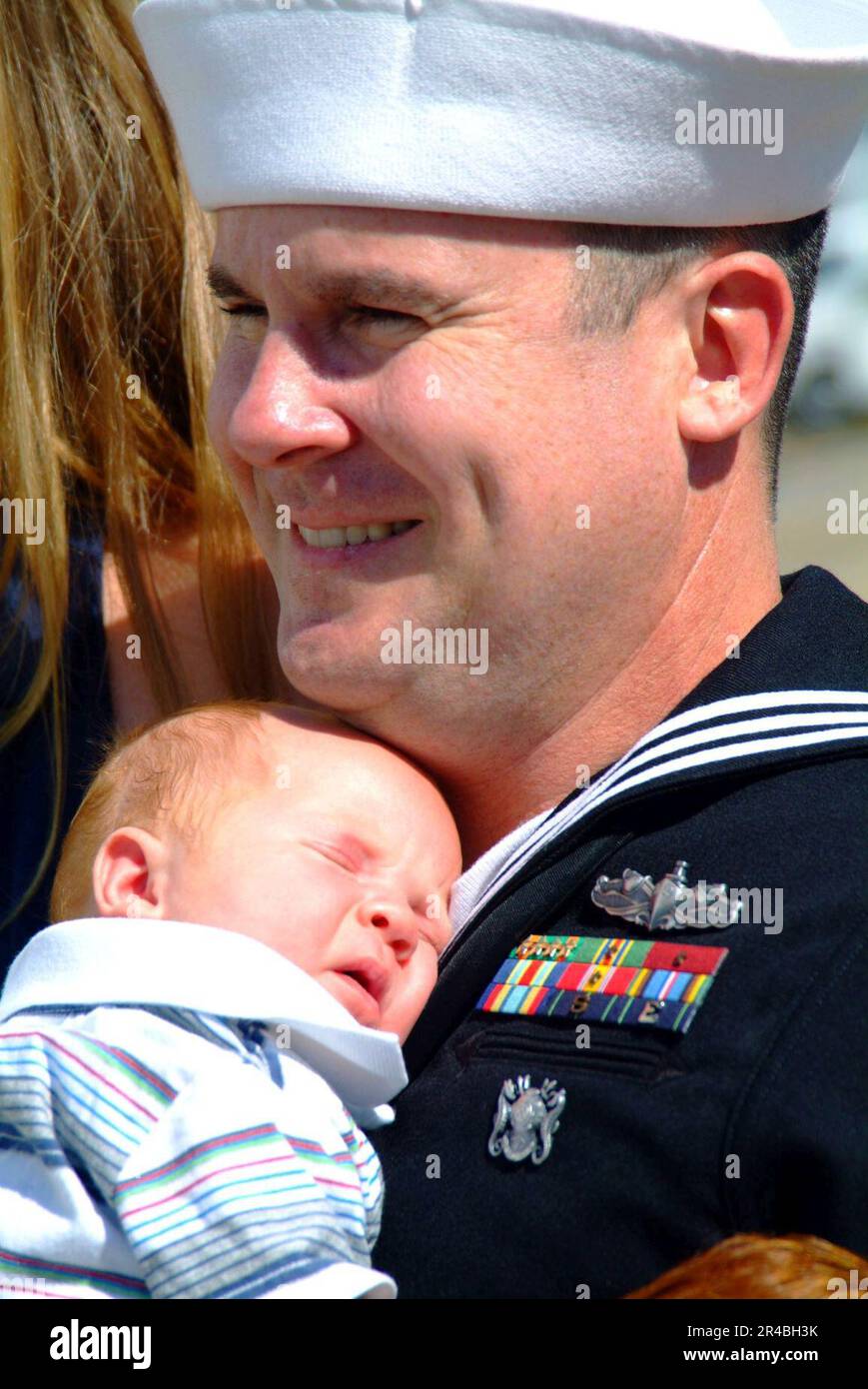 US Navy Hospital Corpsman 1st Class holds his 8-week old daughter on ...