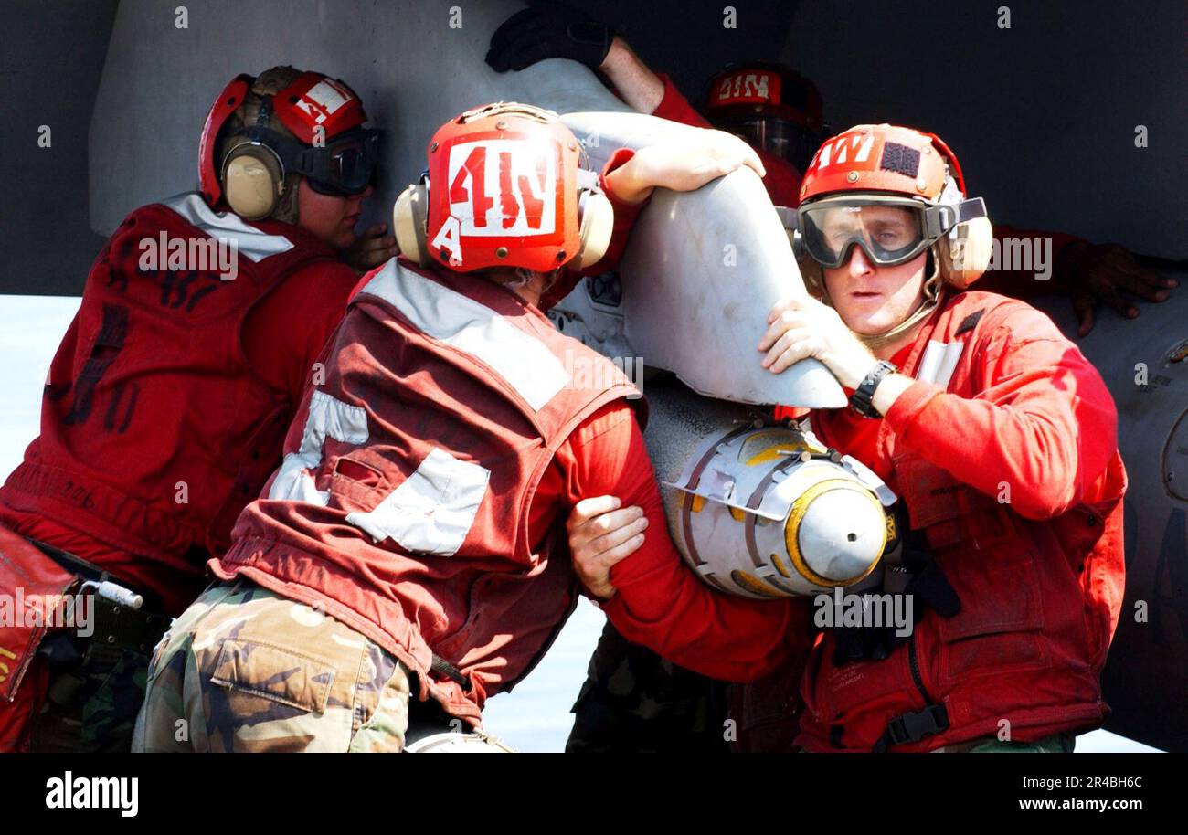 US Navy Aviation Ordnancemen upload a GBU-38 500-pound satellite guided ...
