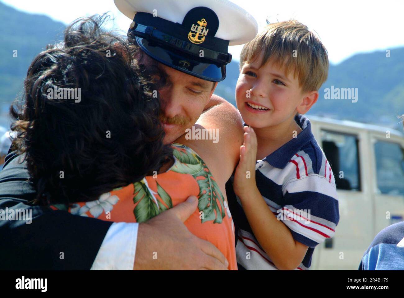 US Navy Chief Hull Technician embraces his wife and son as the rescue ...