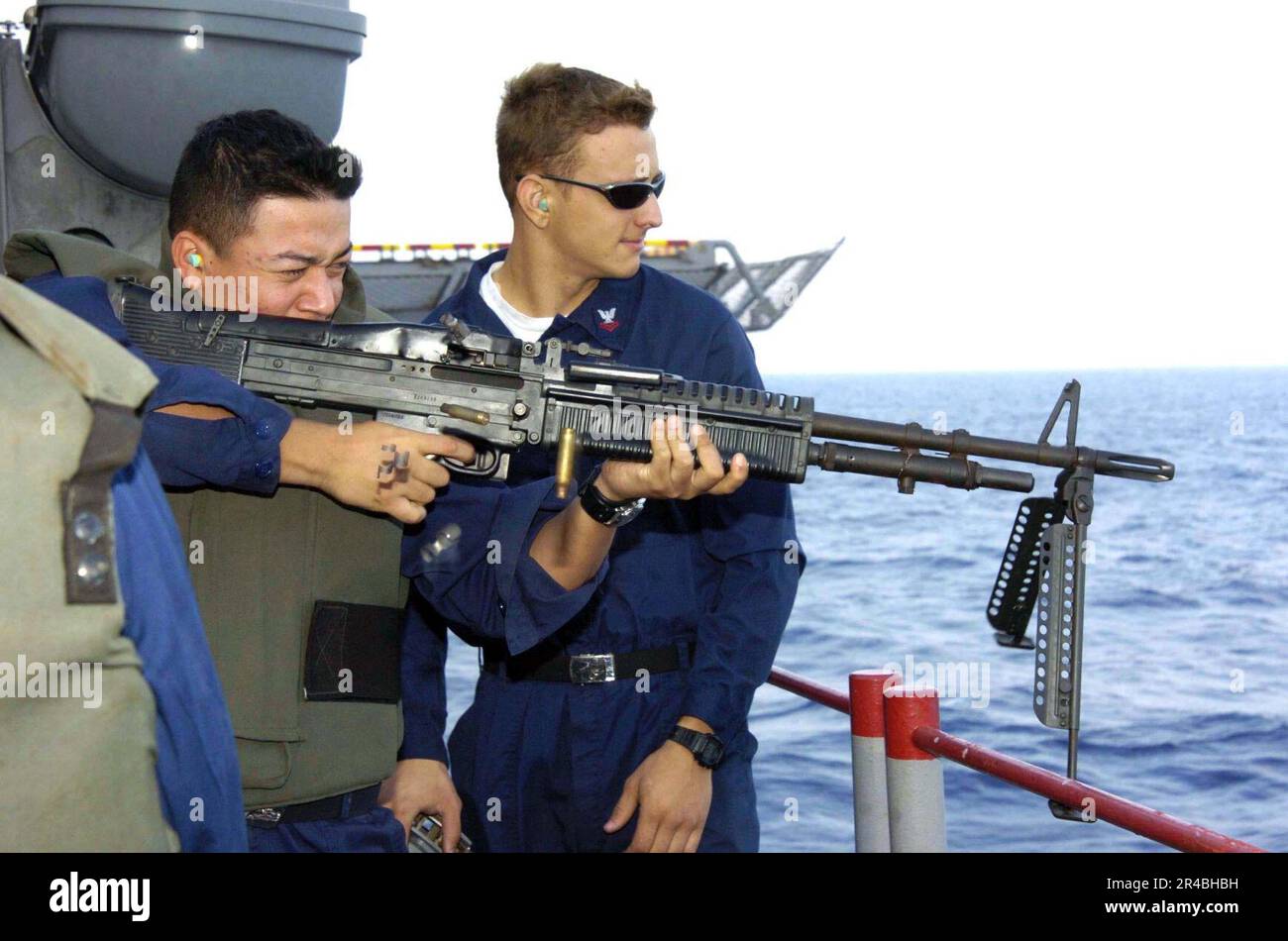 US Navy Gunner's Mate 3rd Class right, observes Religious Program ...