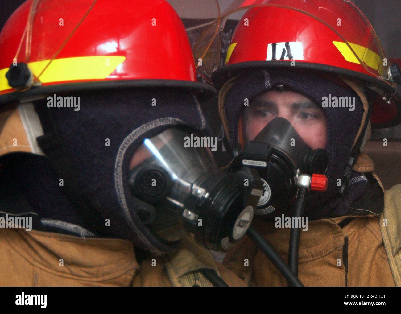 US Navy Two Sailors assigned to repair locker One Alpha don fire ...