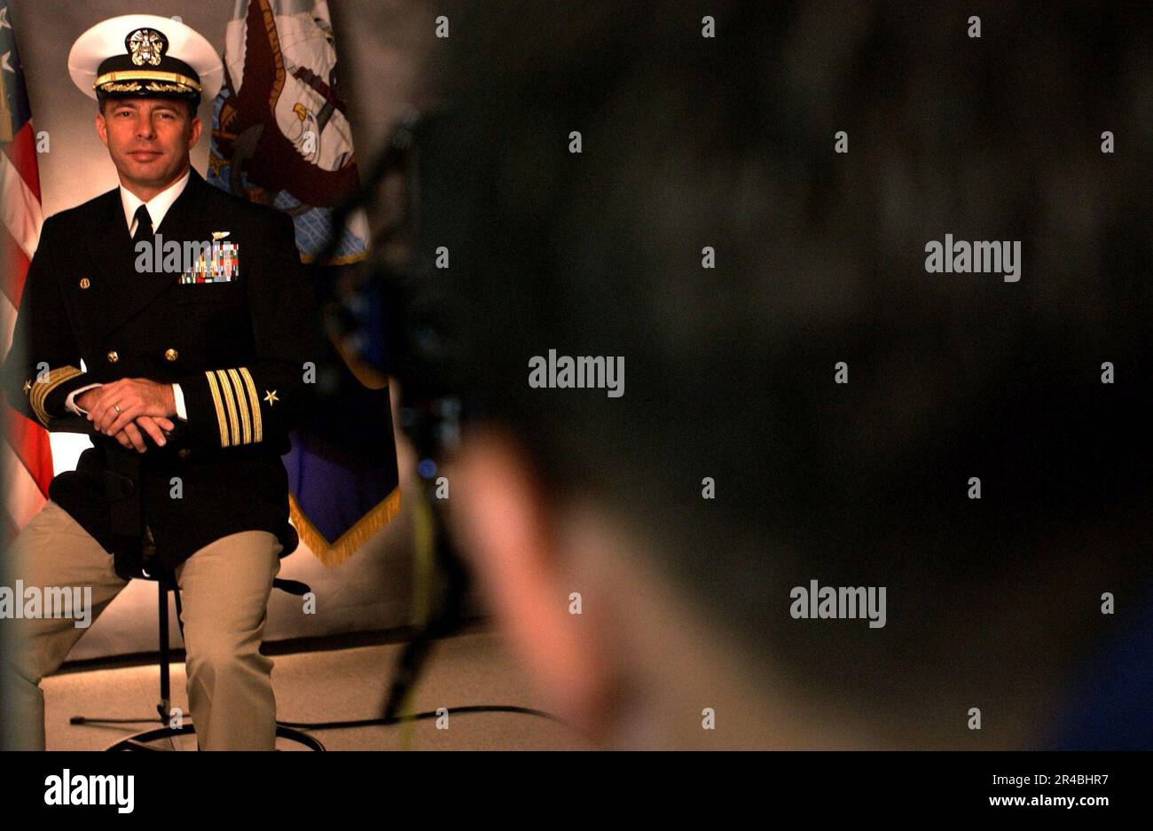 US Navy Photographer's Mate 3rd Class photographs Capt. in the photo ...