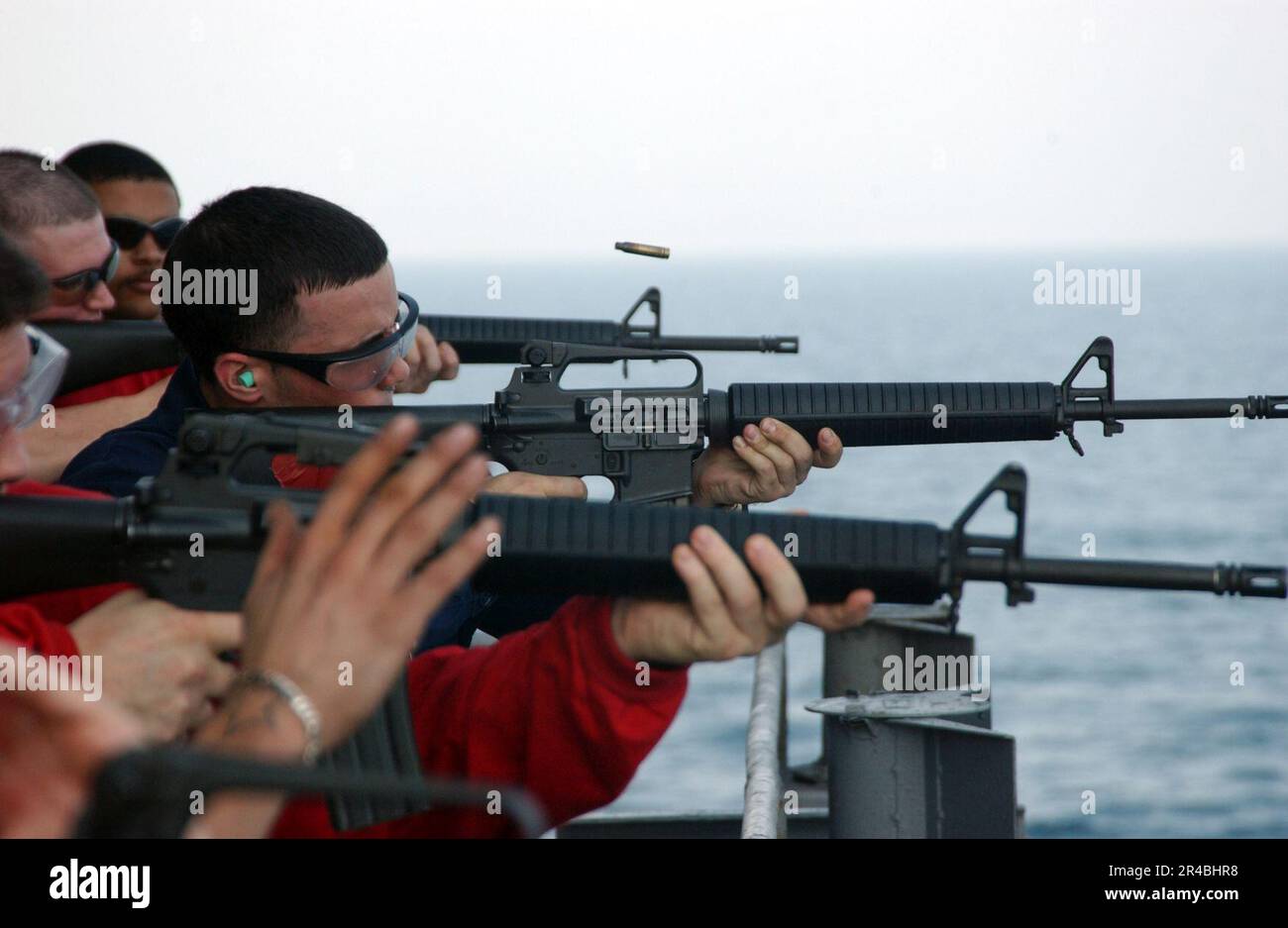US Navy Crew members fire M-16 rifles during a live fire training ...