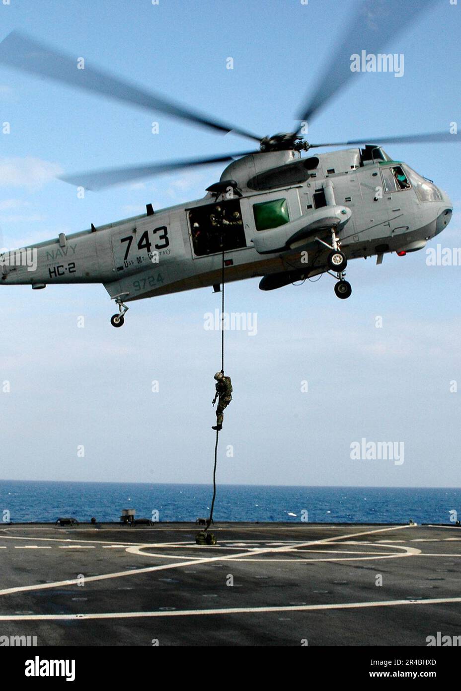 US Navy A Sailor conducts fast roping from a UH-3H Sea King helicopter ...