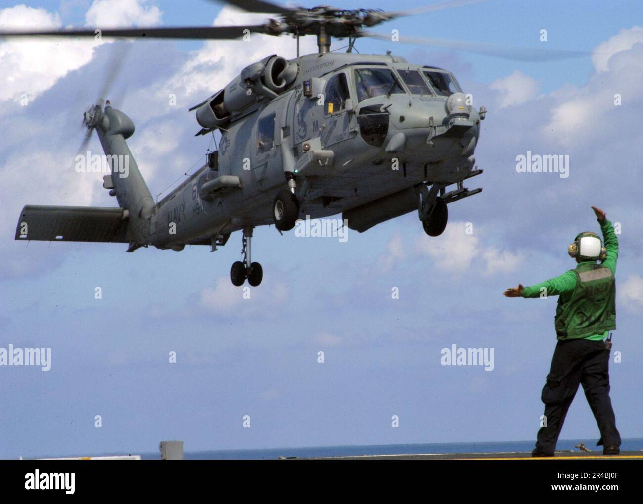 US Navy A Landing Signalman Enlisted (LSE) directs an HH-60H Seahawk ...