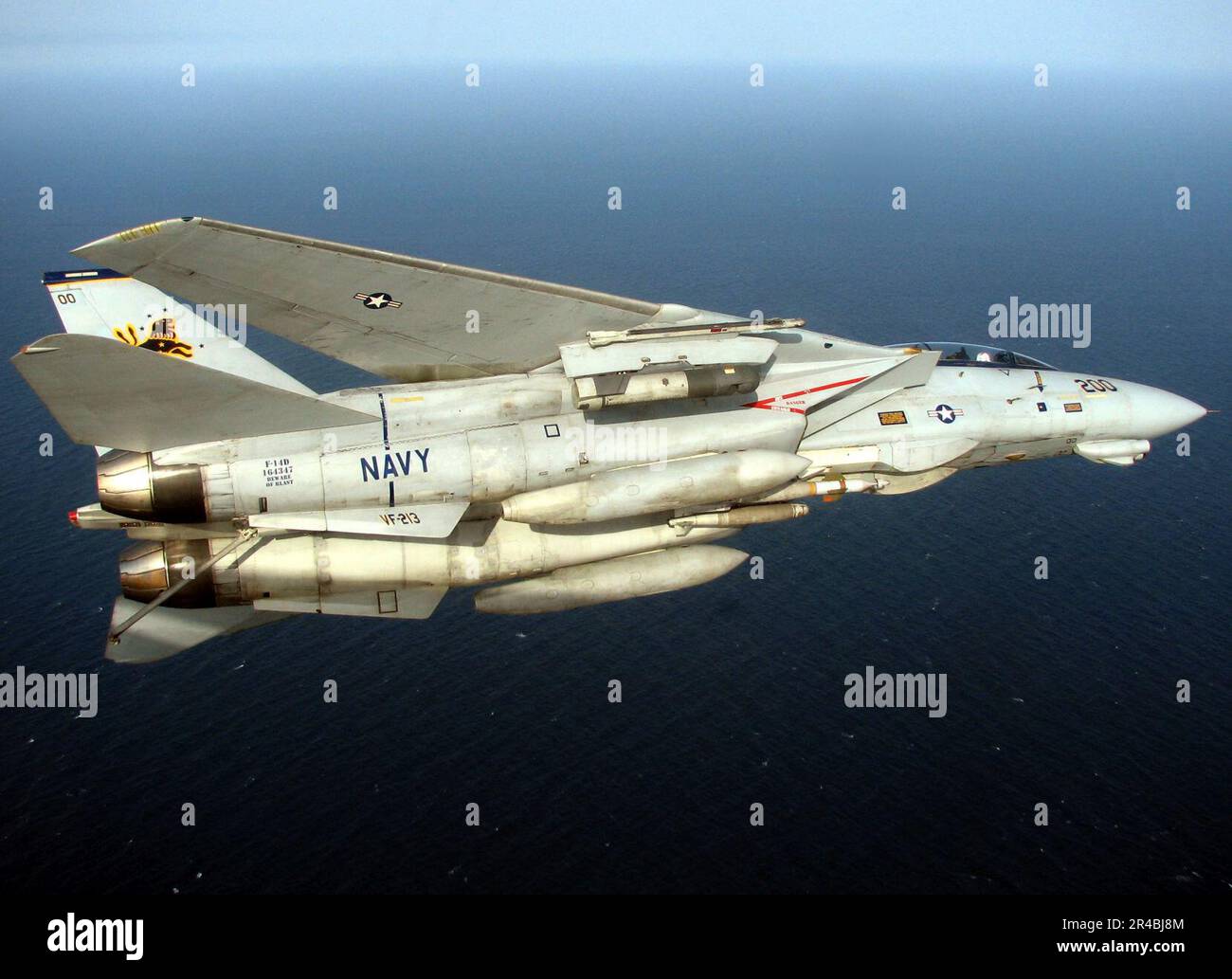 US Navy An F-14D Tomcat banks with its tailhook lowered in preparation ...