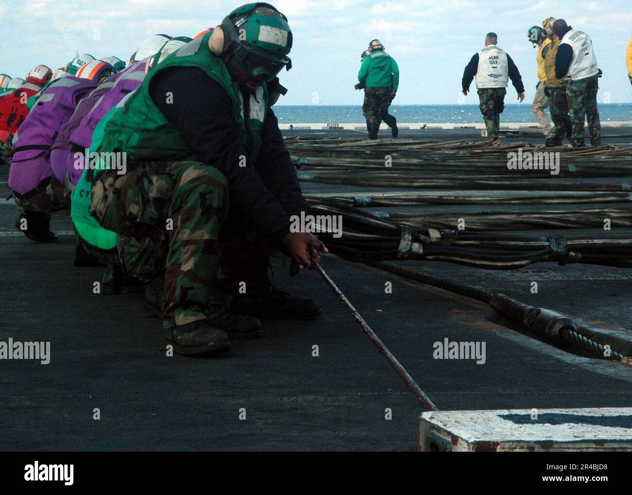 US Navy A Sailor assigned to the Air Department, V-2 Division, pulls ...
