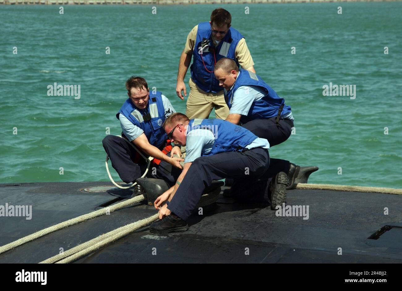 US Navy Sailors secure a mooring line to the Los Angeles-class fast ...