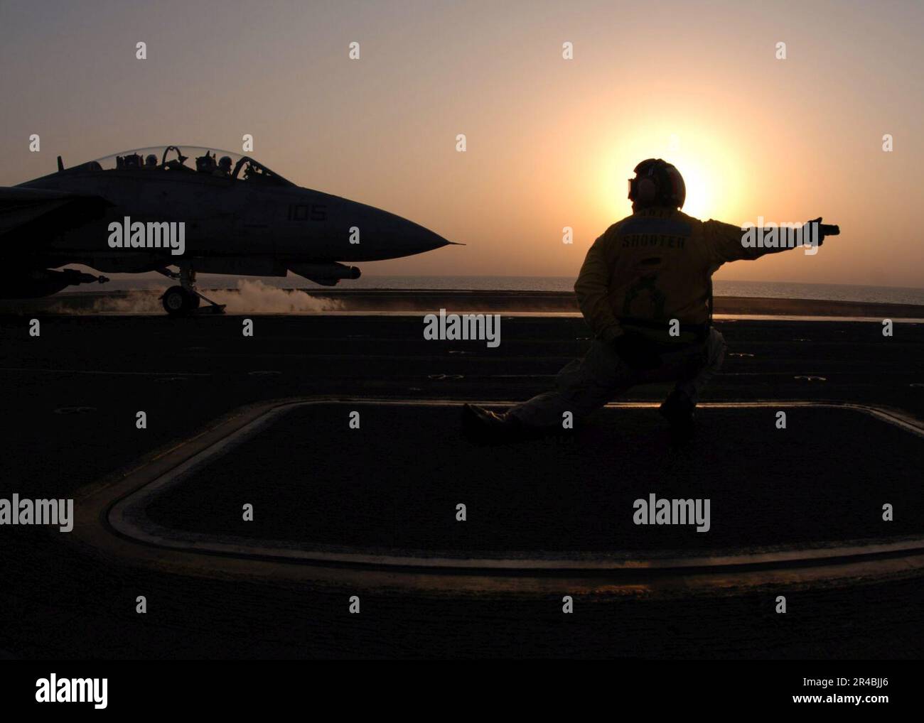 US Navy A catapult shooter signals the launch of an F-14D Tomcat from ...