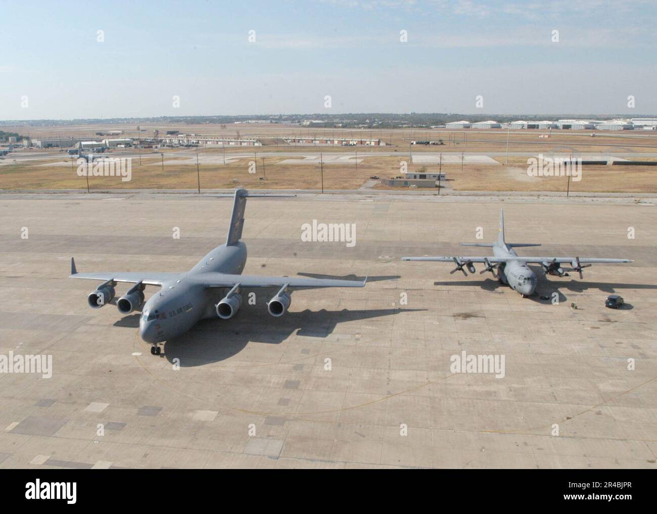 US Navy A U.S. Air Force C-17 Globemaster III and a C-130 Hercules sit ...