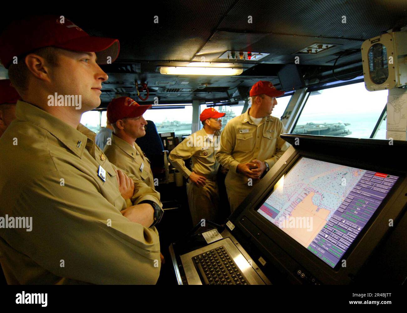 US Navy Officers of the deck look over the pier at Naval Station ...